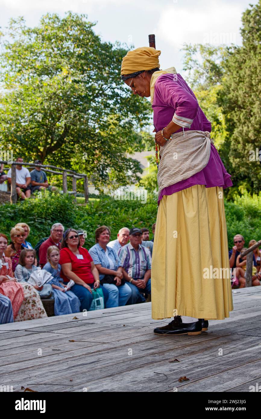 historic interpreter, woman, black slave, slightly bent forward ...