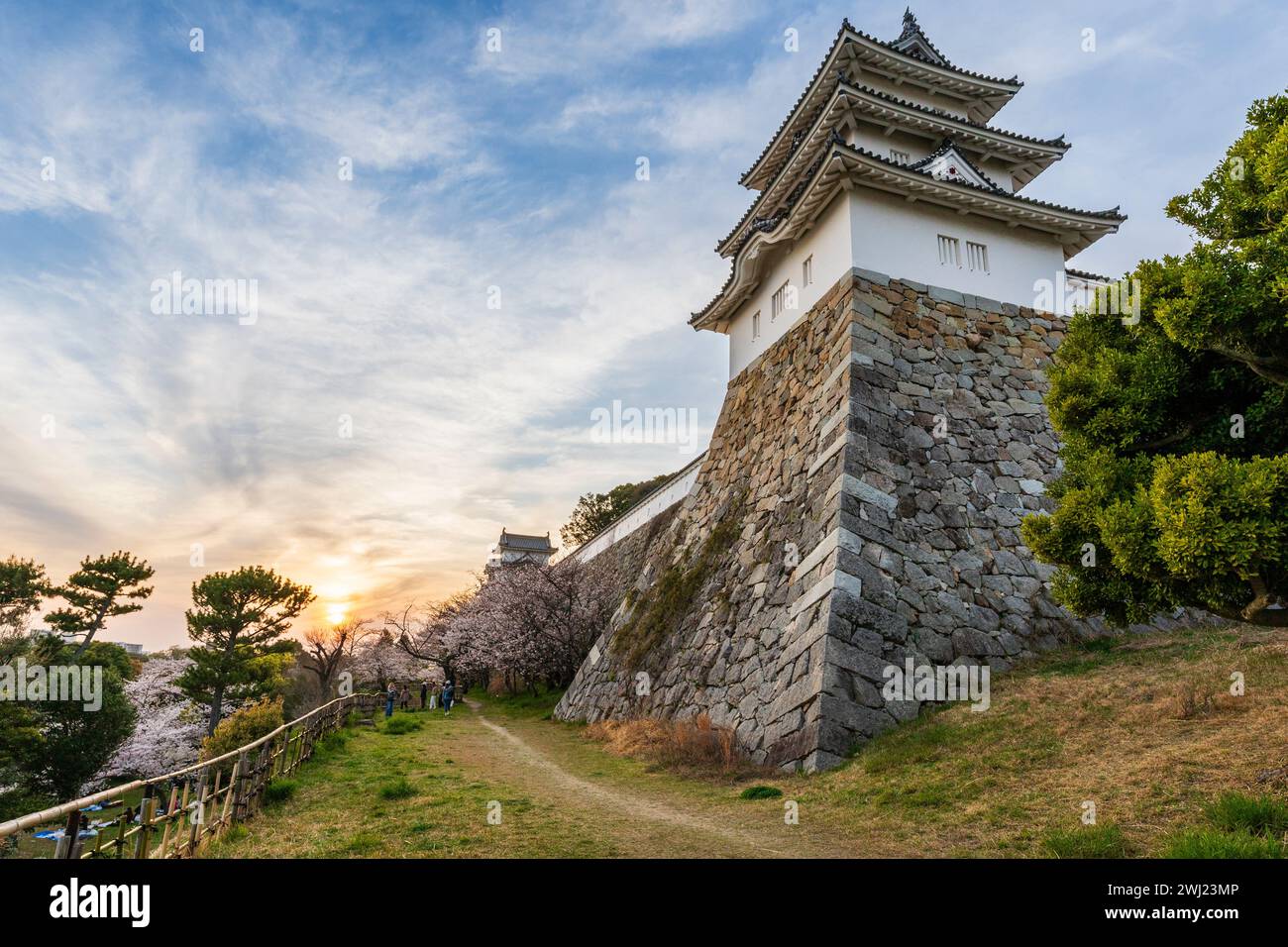 Path running along the tall ishigaki stone walls and two turrets of ...