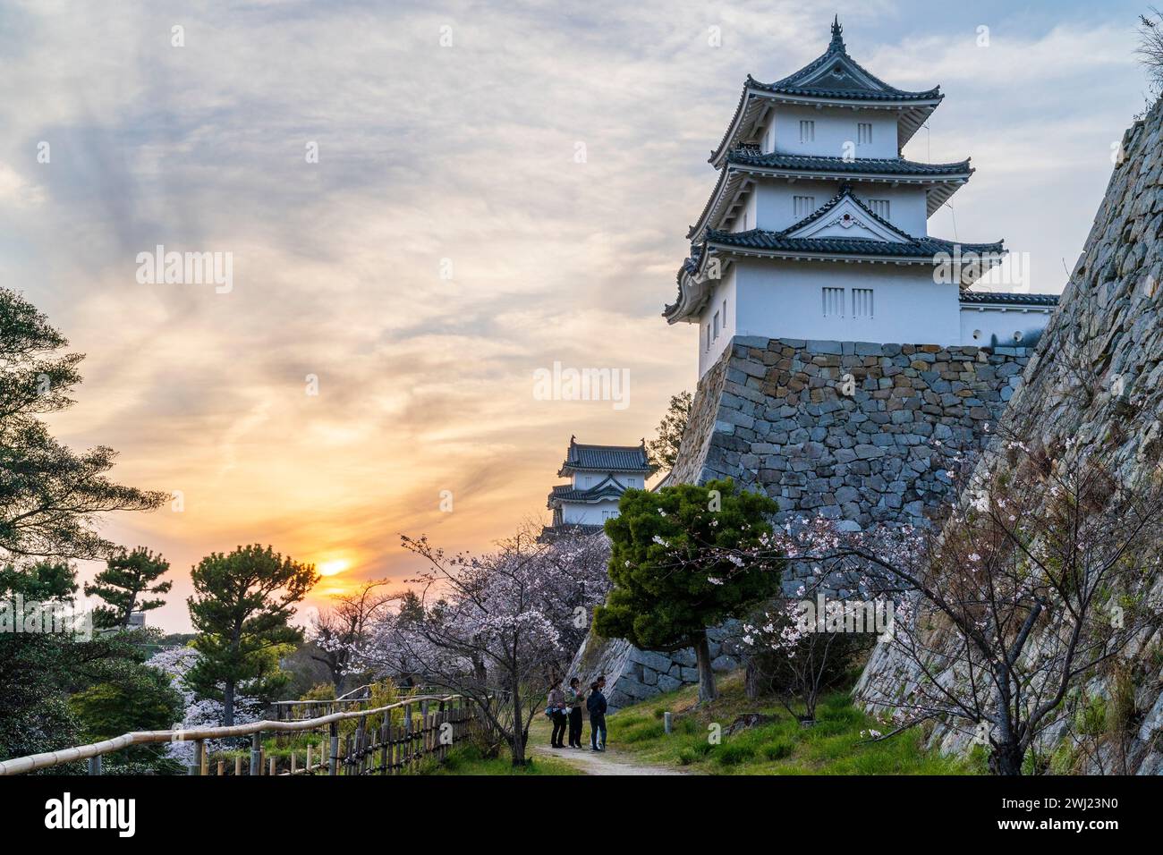Path running along the tall ishigaki stone walls and two turrets of ...