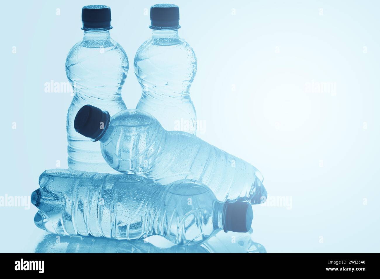 Blue bottles of pure still water against white background Stock Photo ...