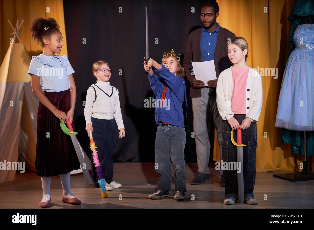 Full length portrait of young boy playing valiant prince on stage in ...