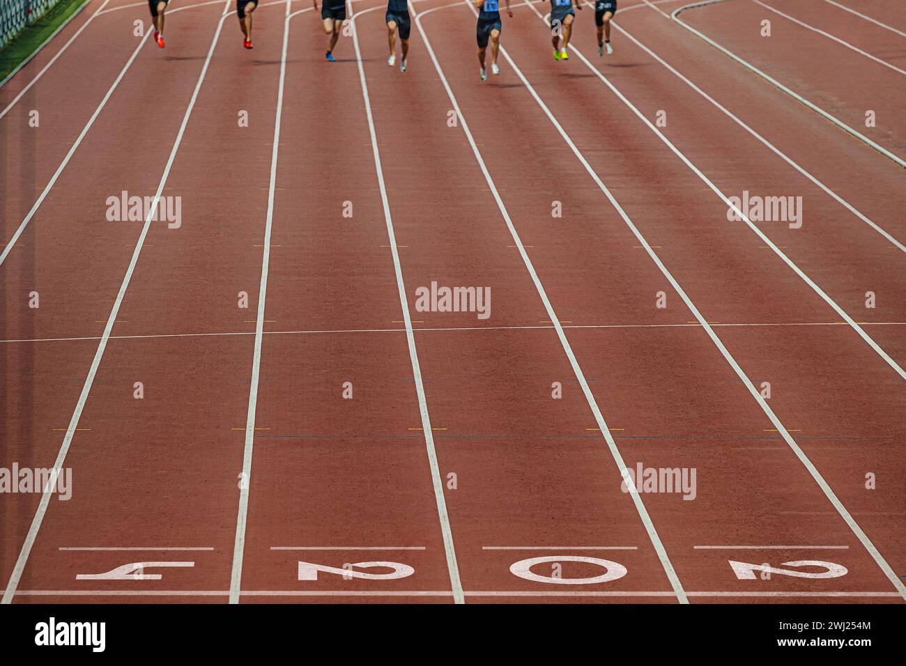 “2024” in white on finish line red running track, symbolizing summer ...