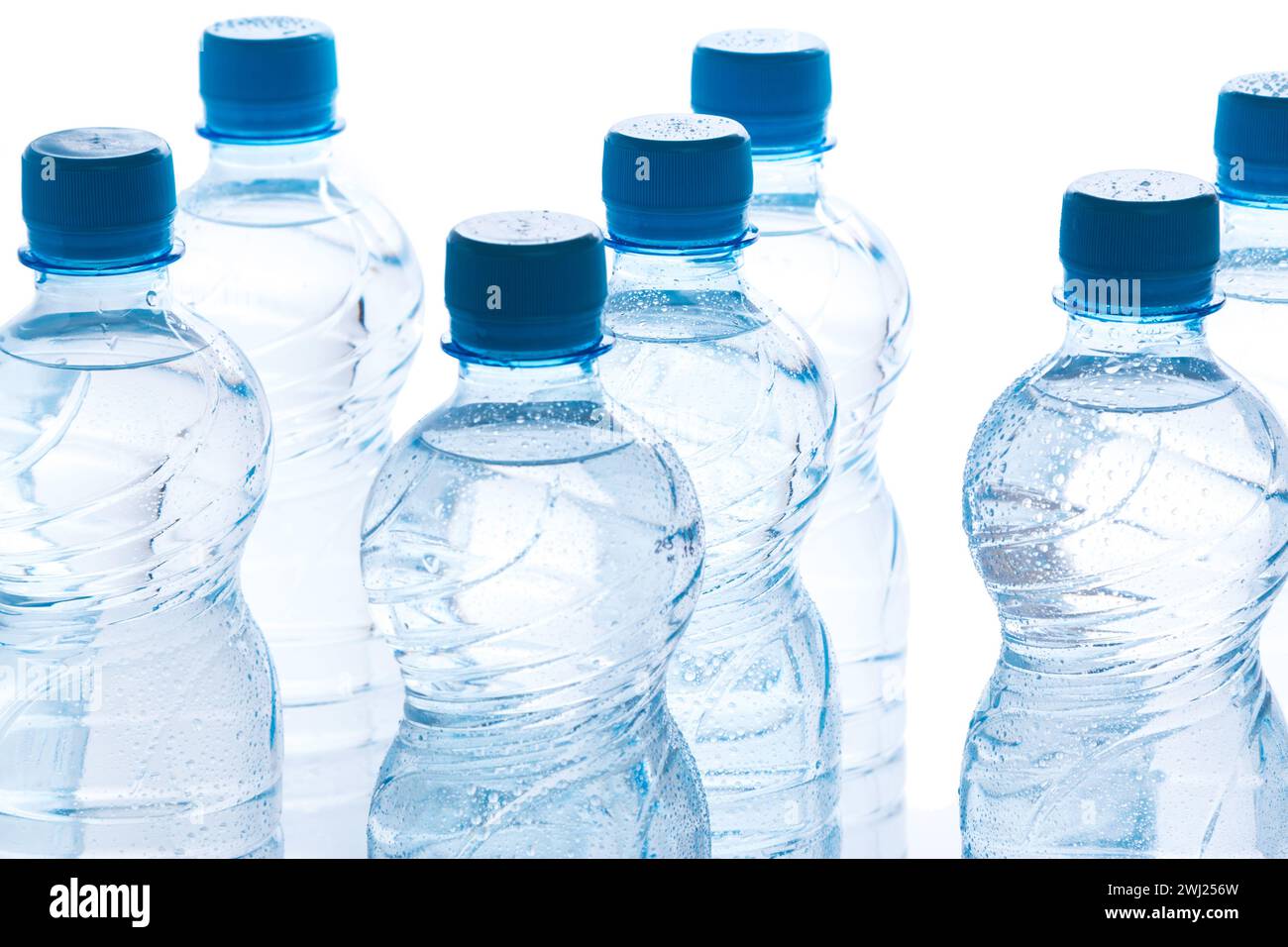 Blue bottles of pure still water against white background Stock Photo ...