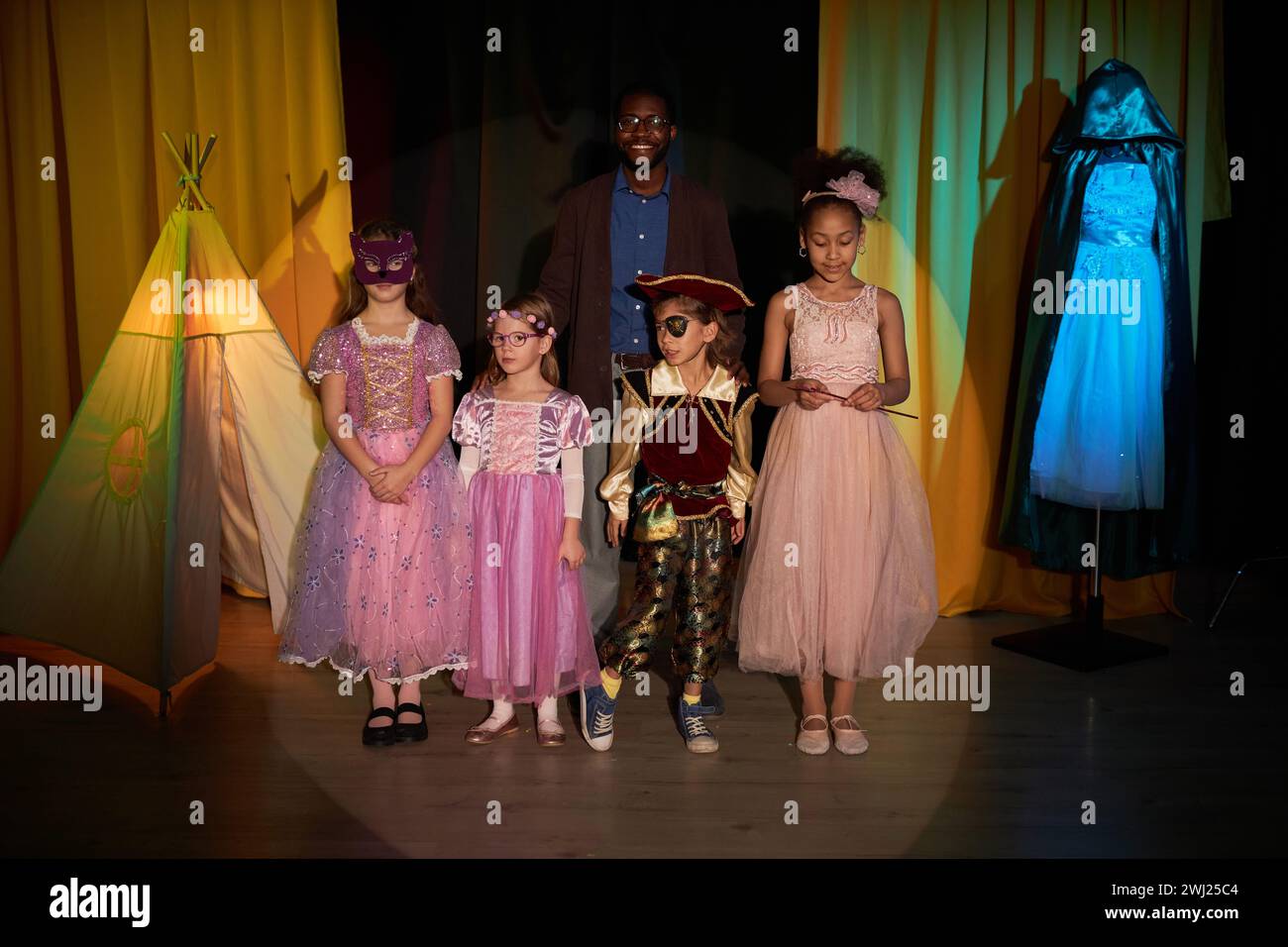 Full length portrait of group of little kids standing on stage in ...