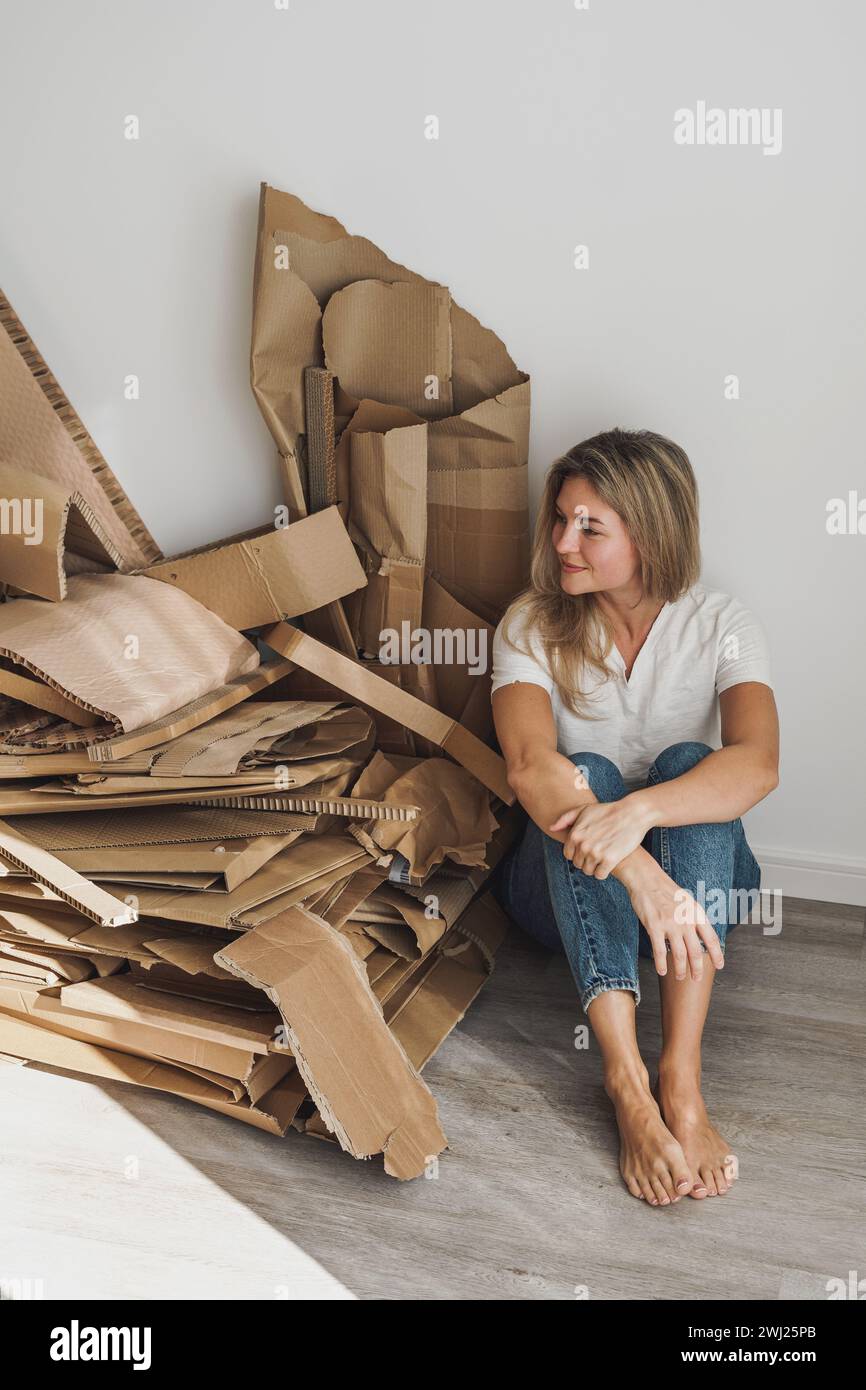 Young woman wand stack of cardboard waste at home. Concepts of Paper ...