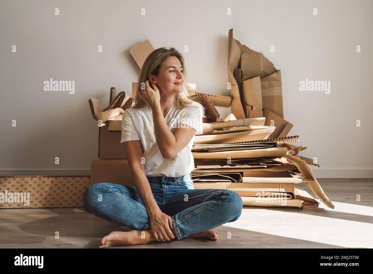 Young woman wand stack of cardboard waste at home. Concepts of Paper ...