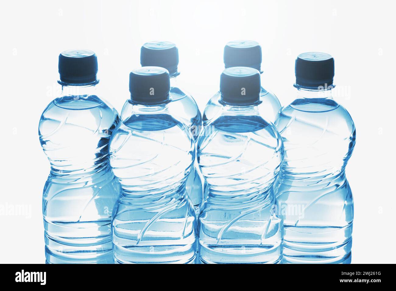Blue bottles of pure still water against white background Stock Photo ...