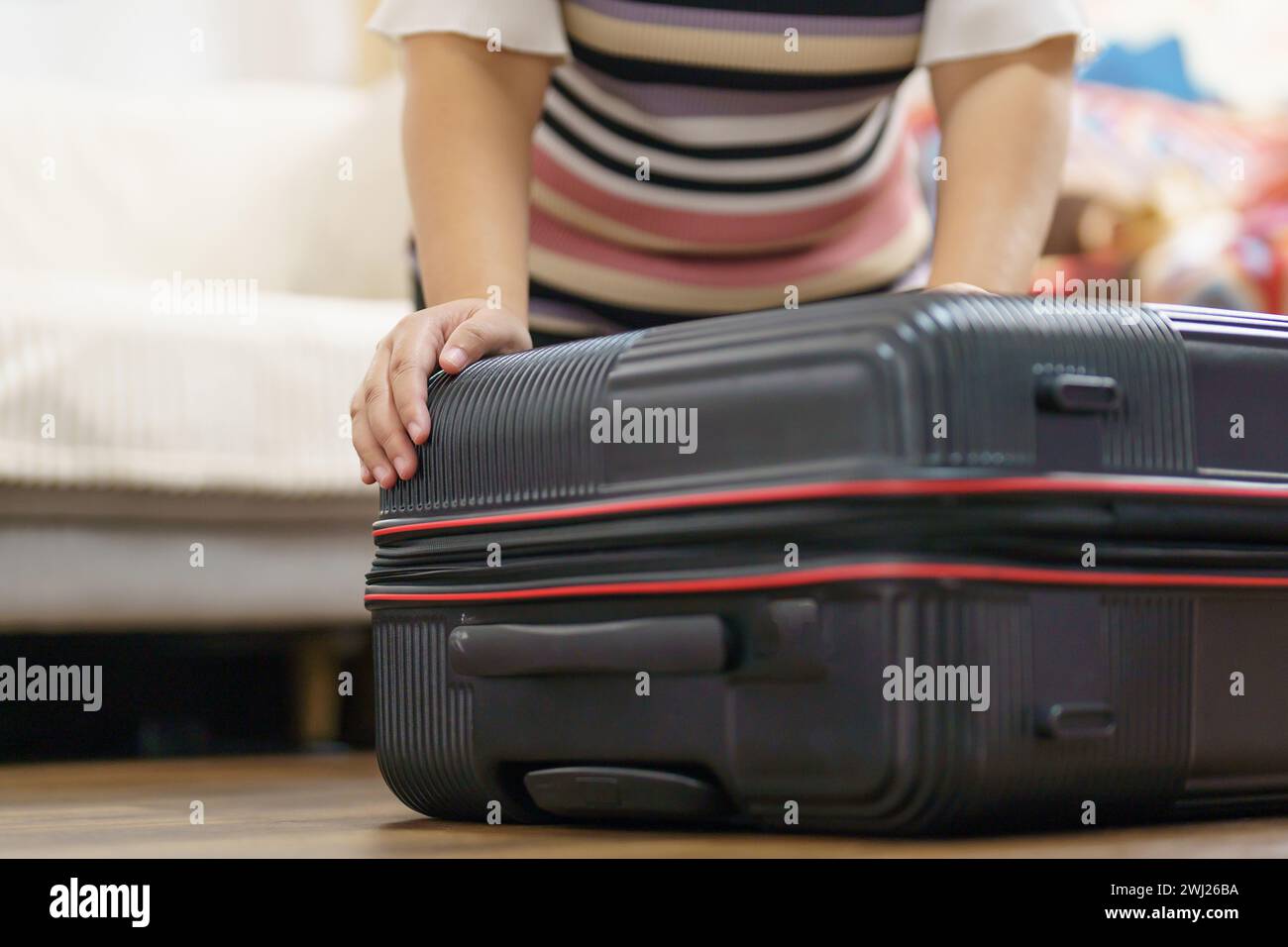 Woman preparing luggage Â packing in suitcase Â trolley luggage Stock ...