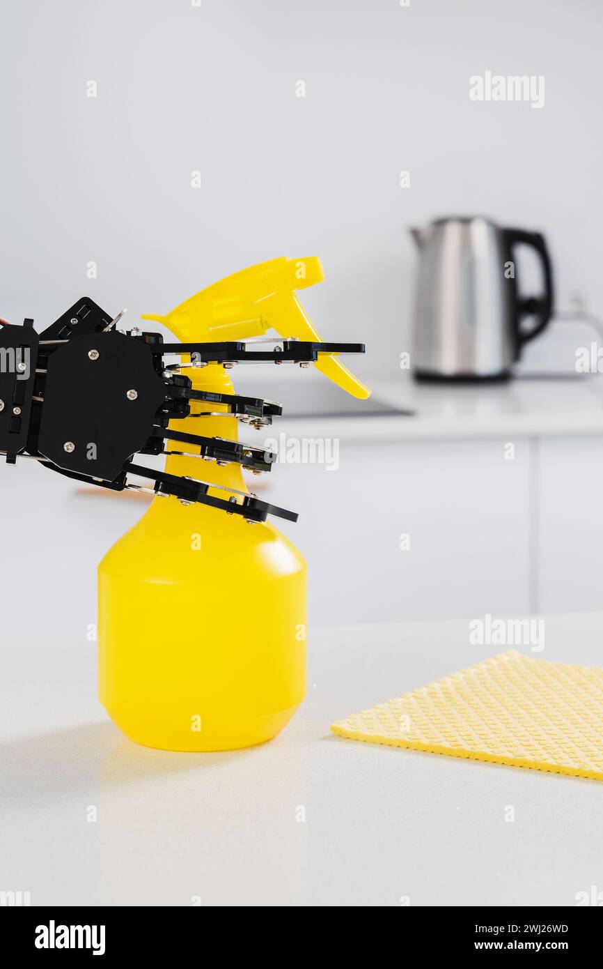 Real robot's hand with spray cleaner in white kitchen. Concept of ...