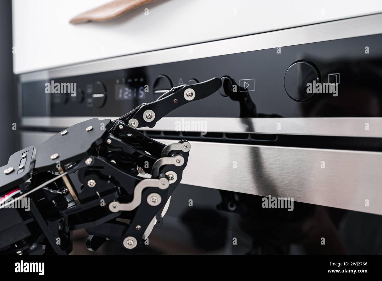 Real robot's hand and microwave oven. Concept of robotic process ...