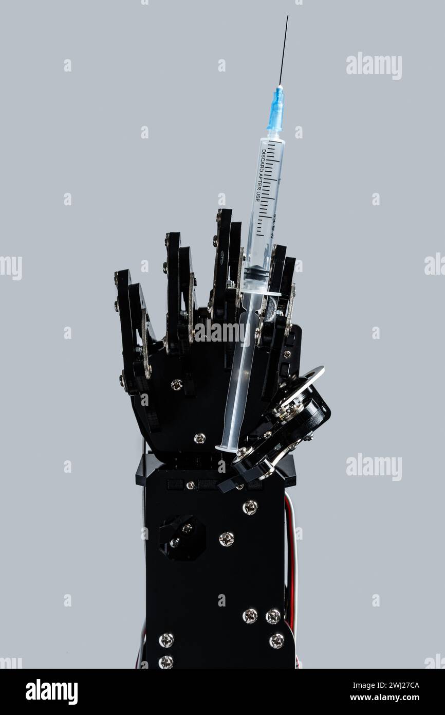 Real robotic hand with syringe. Concept of Artificial intelligence and ...