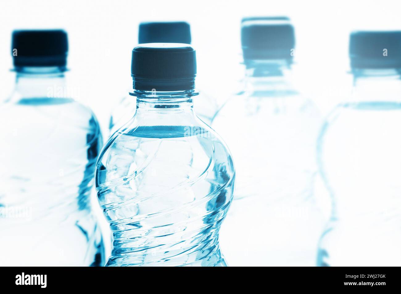 Blue bottles of pure still water against white background Stock Photo ...