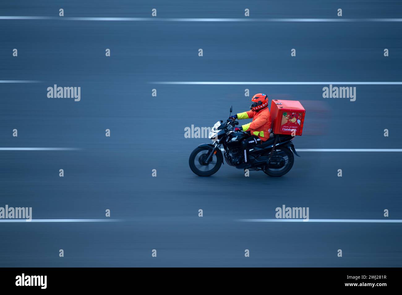 Delivery boy Talabat food Delivery rider on road Stock Photo - Alamy