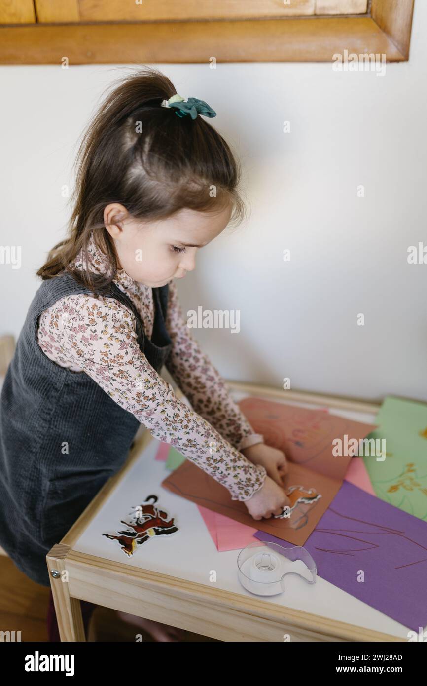 Toddler girl doing a craft Stock Photo - Alamy