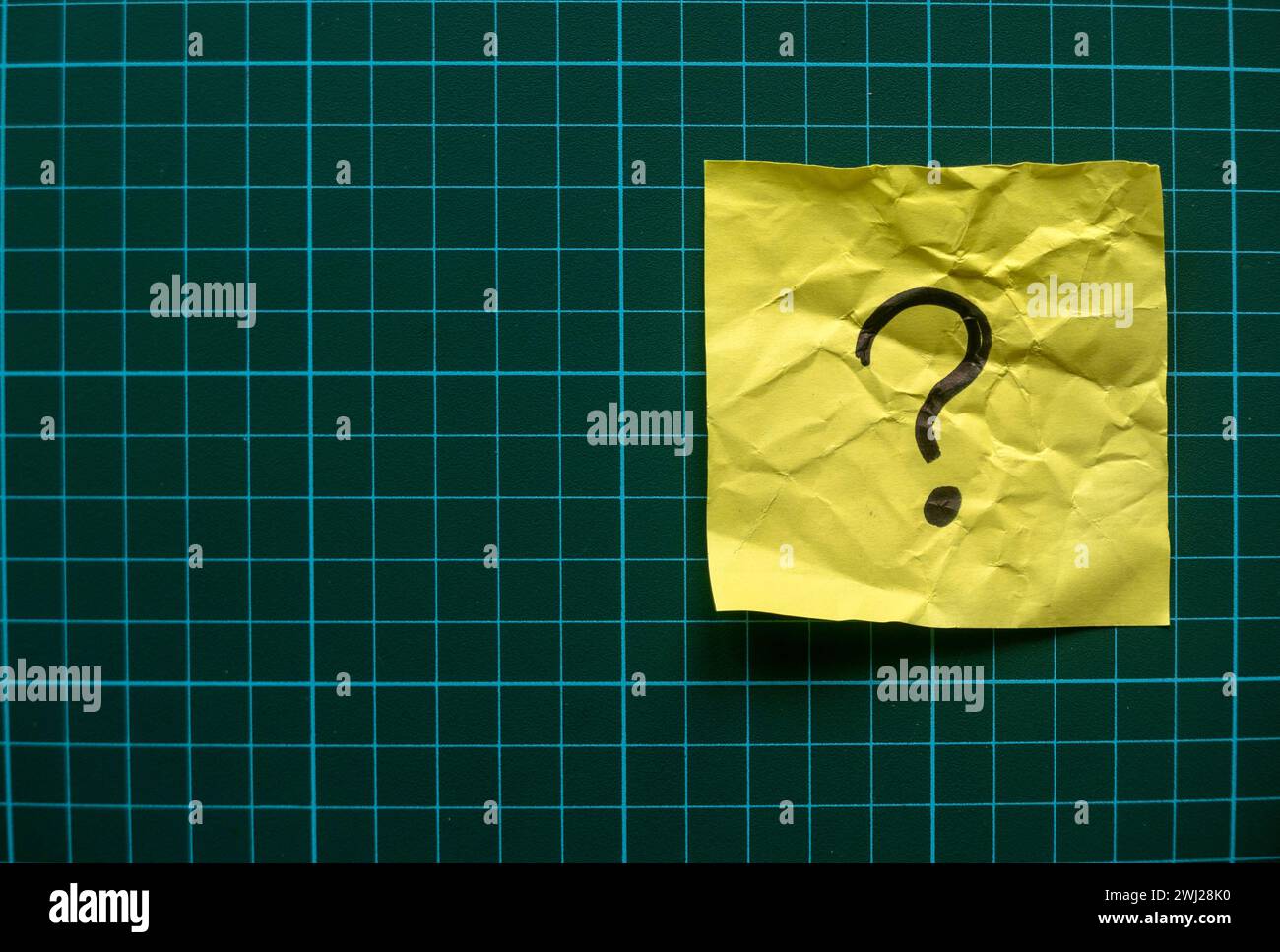 Q&A or questions and answers concept. Crumpled paper note written with ...