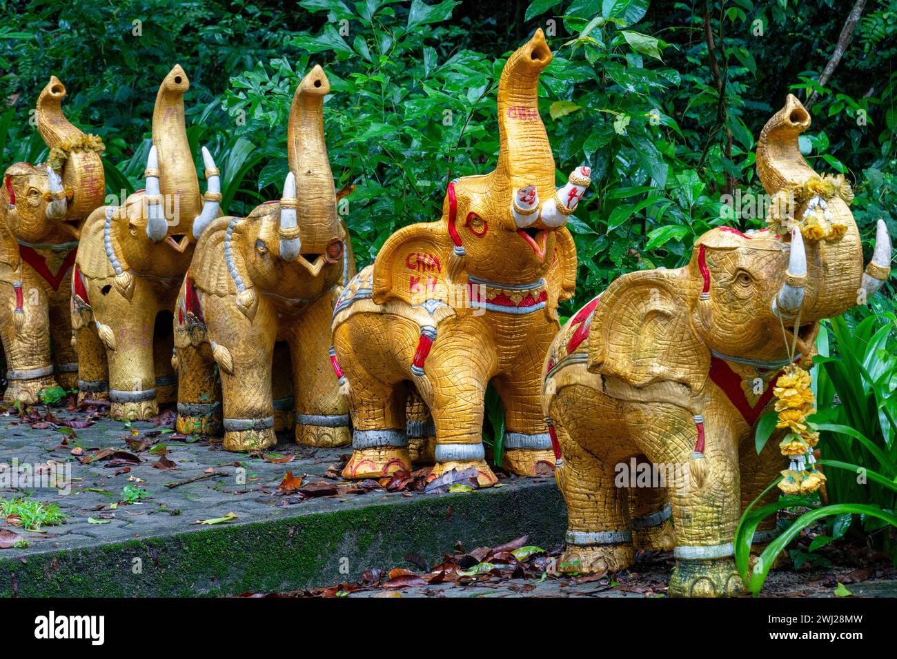 Golden elephant statues in front of Thai temple Stock Photo - Alamy