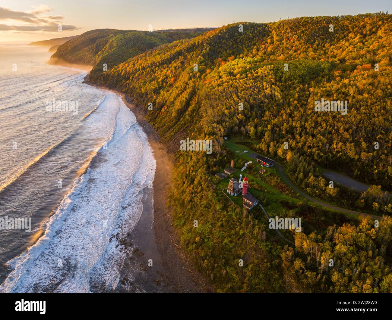Sunrise at Lighthouse and Ocean Cliffs Covered in Fall Colors Stock ...