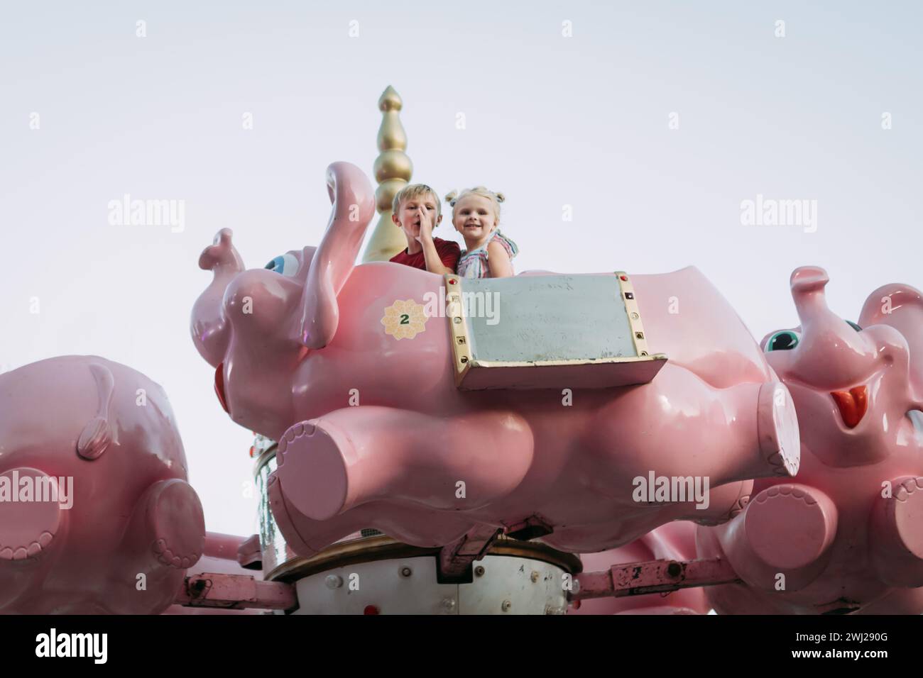 Kids on elephant carnival ride at county fair Stock Photo - Alamy