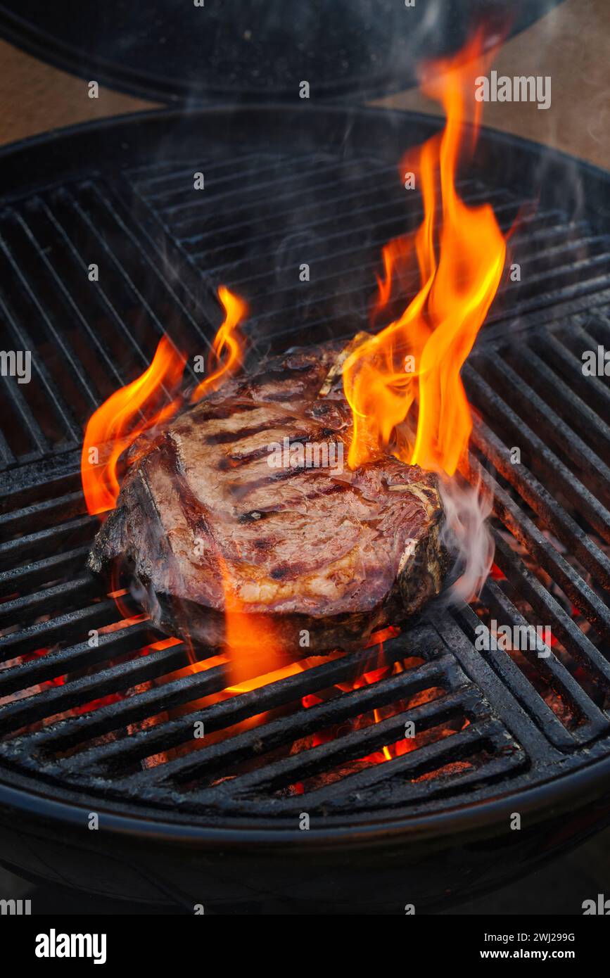Barbecue dry aged wagyu prime rib beef steak grilled as close-up on a ...