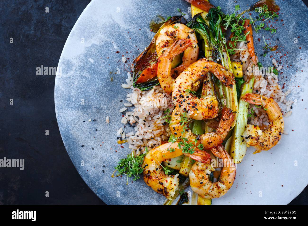 Traditional Thai fried king prawns with Asian vegetable and rice served ...