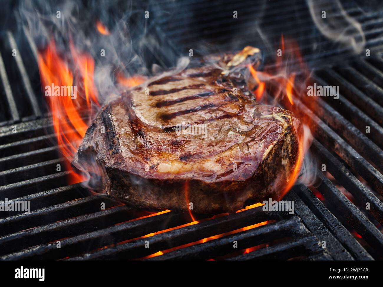 Barbecue dry aged wagyu prime rib beef steak grilled as close-up on a ...