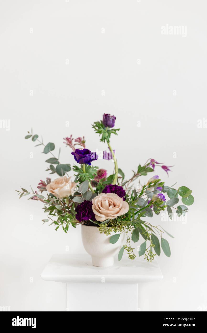 Muted Purple Floral Arrangement in Minimal Home Setting Stock Photo - Alamy