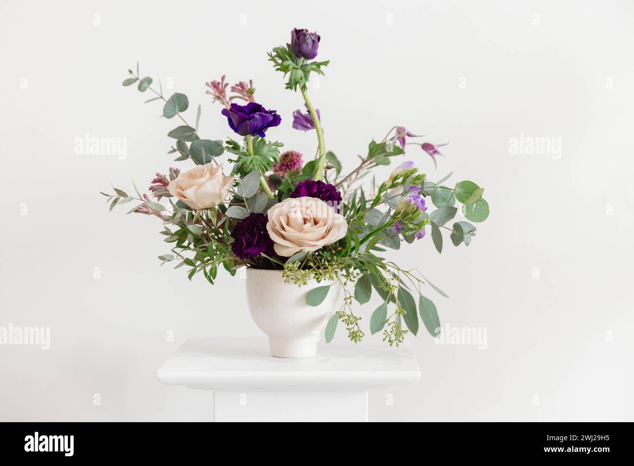 Muted Purple Floral Arrangement in Minimal Home Setting Stock Photo - Alamy