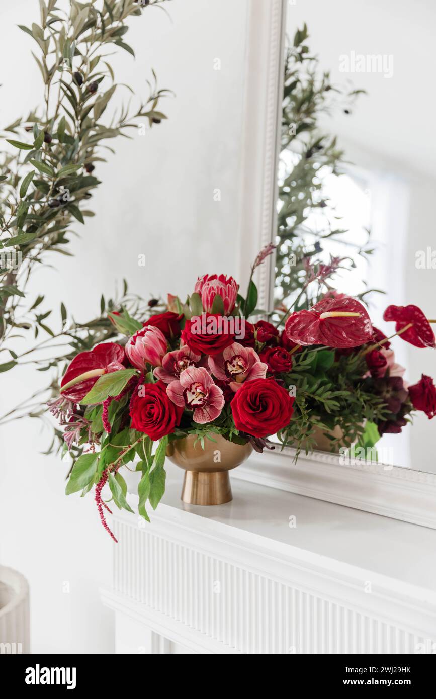 Vibrant Large Shades of Red Floral Arrangement in Gold Vase Stock Photo ...