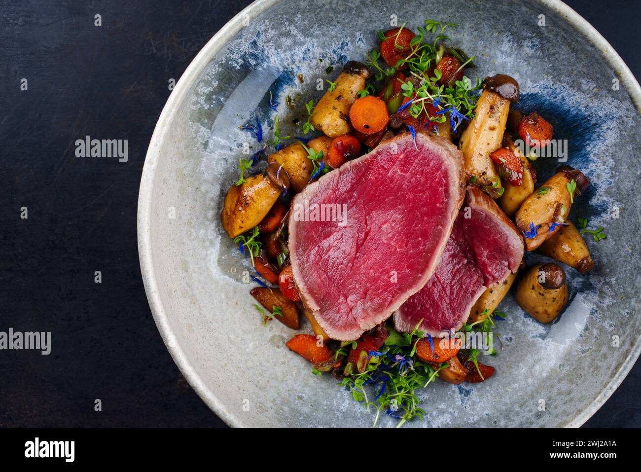 Fried Italian chianina beef fillet steak very rare with mushrooms and ...