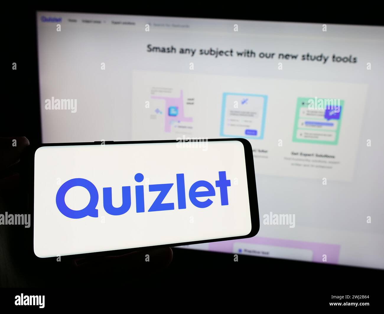 Person holding mobile phone with logo of American online learning ...