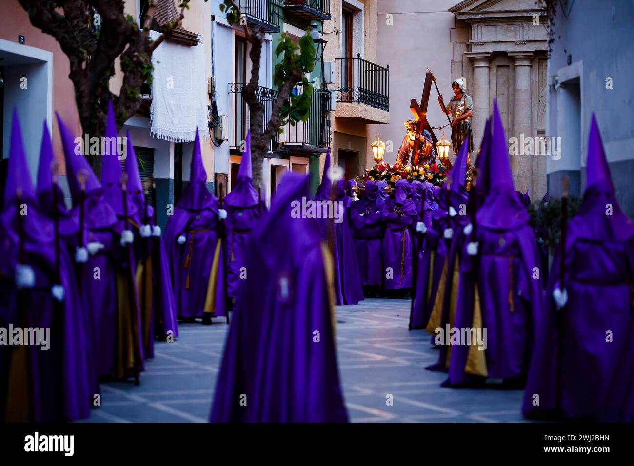 Nazarenes with Christ in the background in Villajoyosa Stock Photo - Alamy