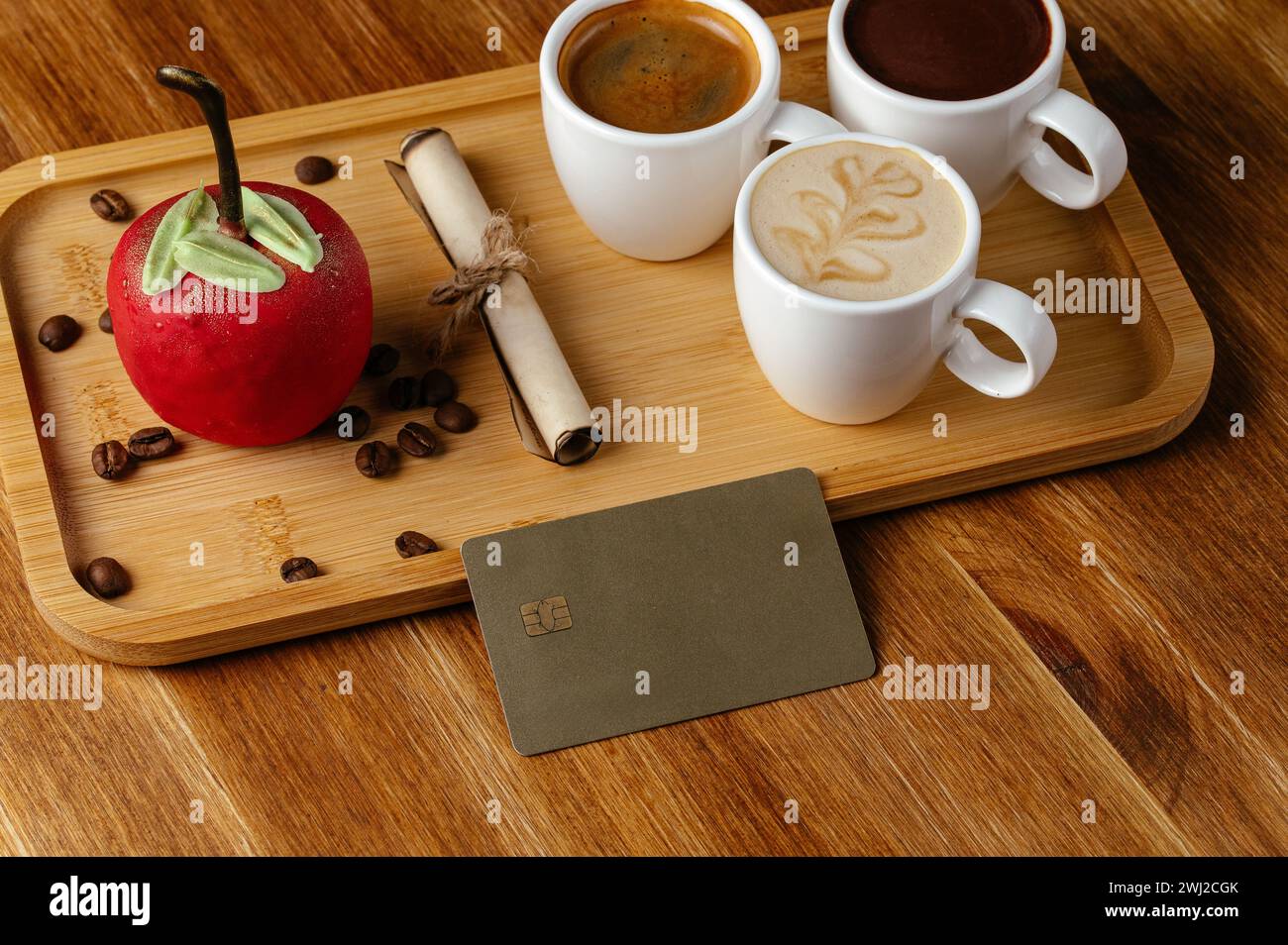 the bank card is on the table in the coffee shop next to the cof Stock ...