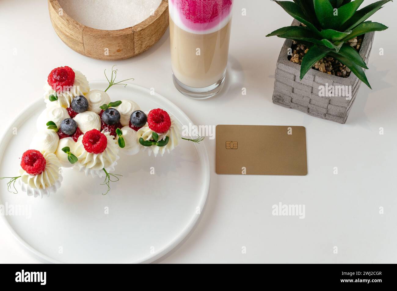 the bank card is on the table in the coffee shop next to the cof Stock ...