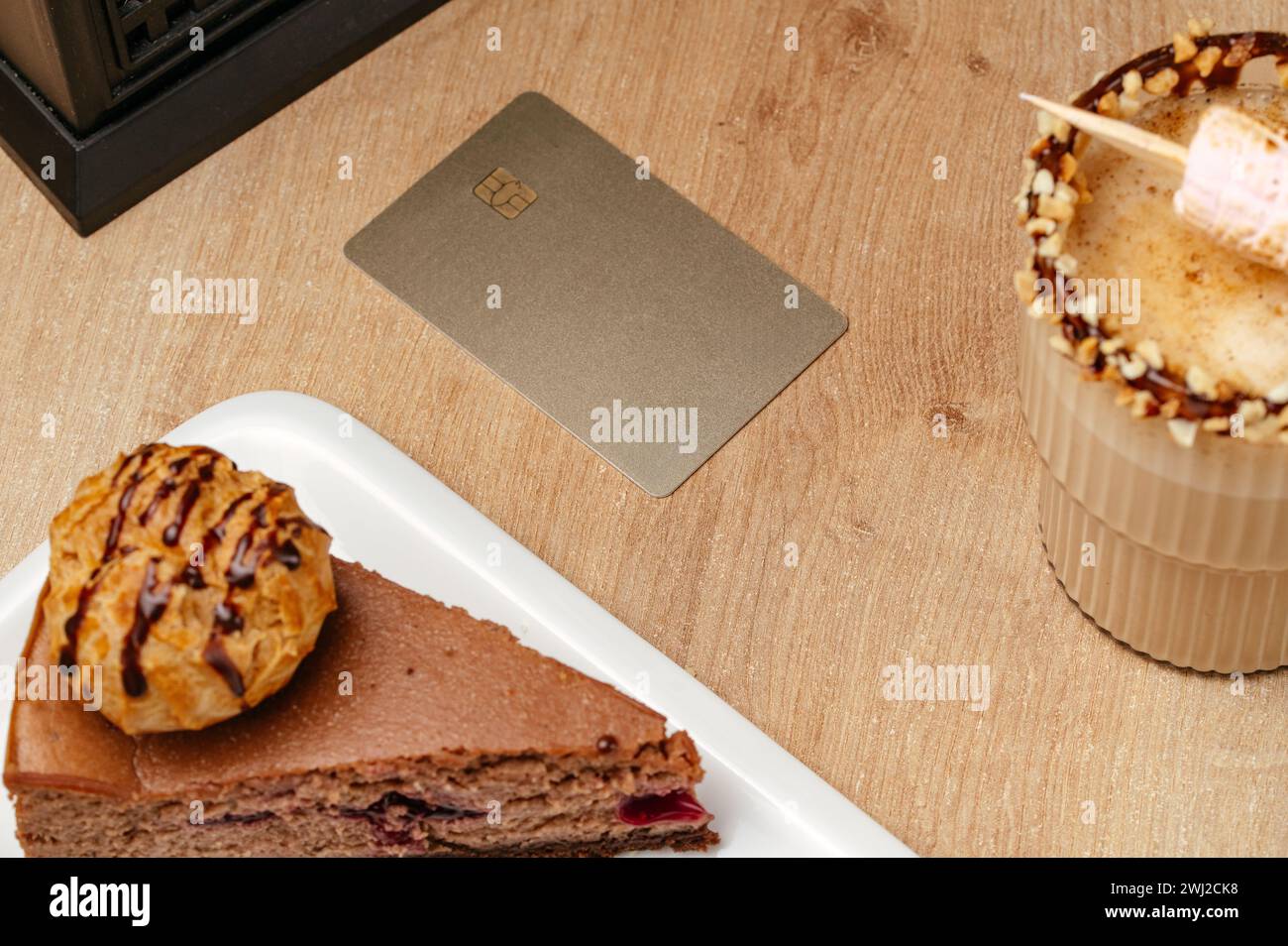 the bank card is on the table in the coffee shop next to the cof Stock ...