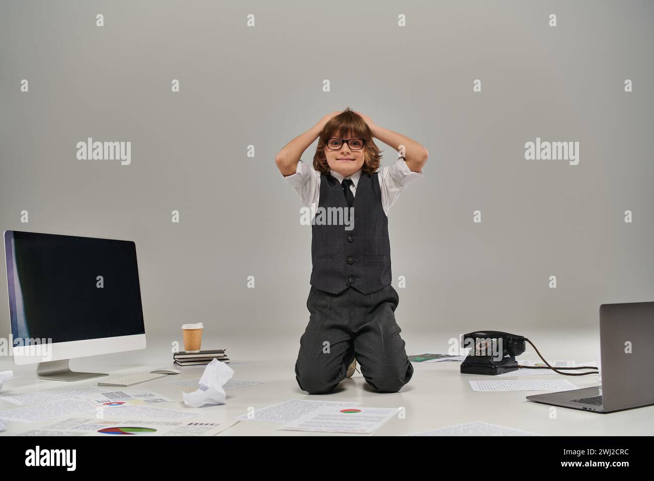 stressed boy in glasses surrounded by papers and office supplies on ...