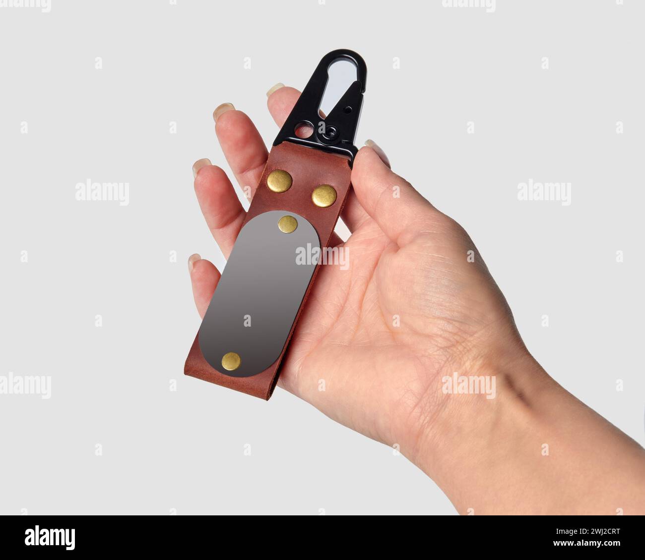 Female hand displaying bespoke brown leather keychain with baby photo ...