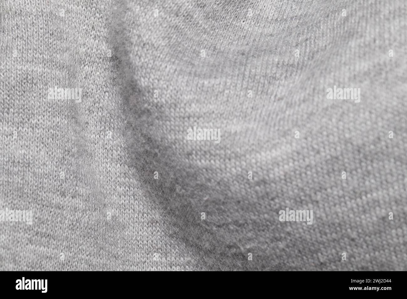 This image shows a close-up view of a gray knitted fabric, highlighting ...