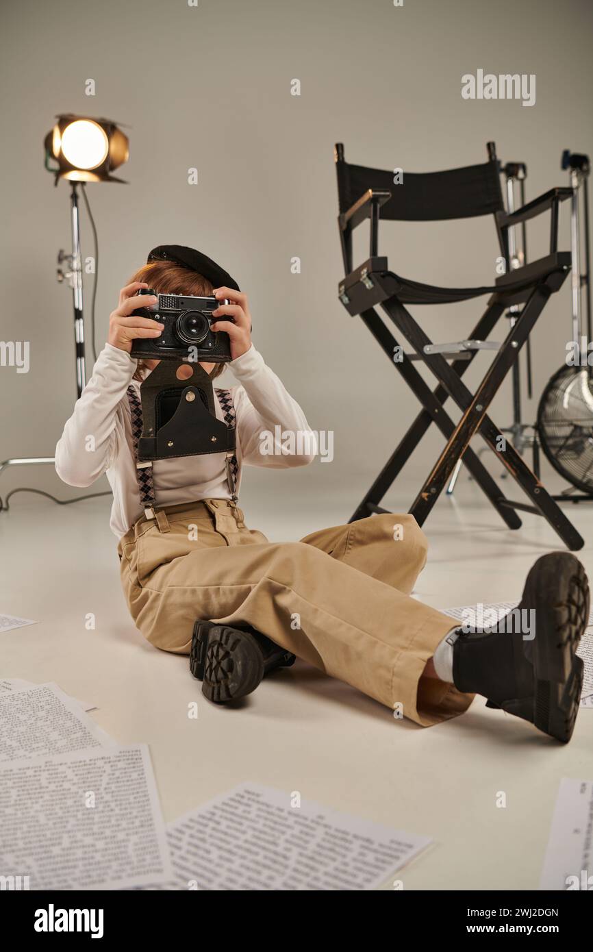 boy captures the moment on camera while sitting surrounded by ...