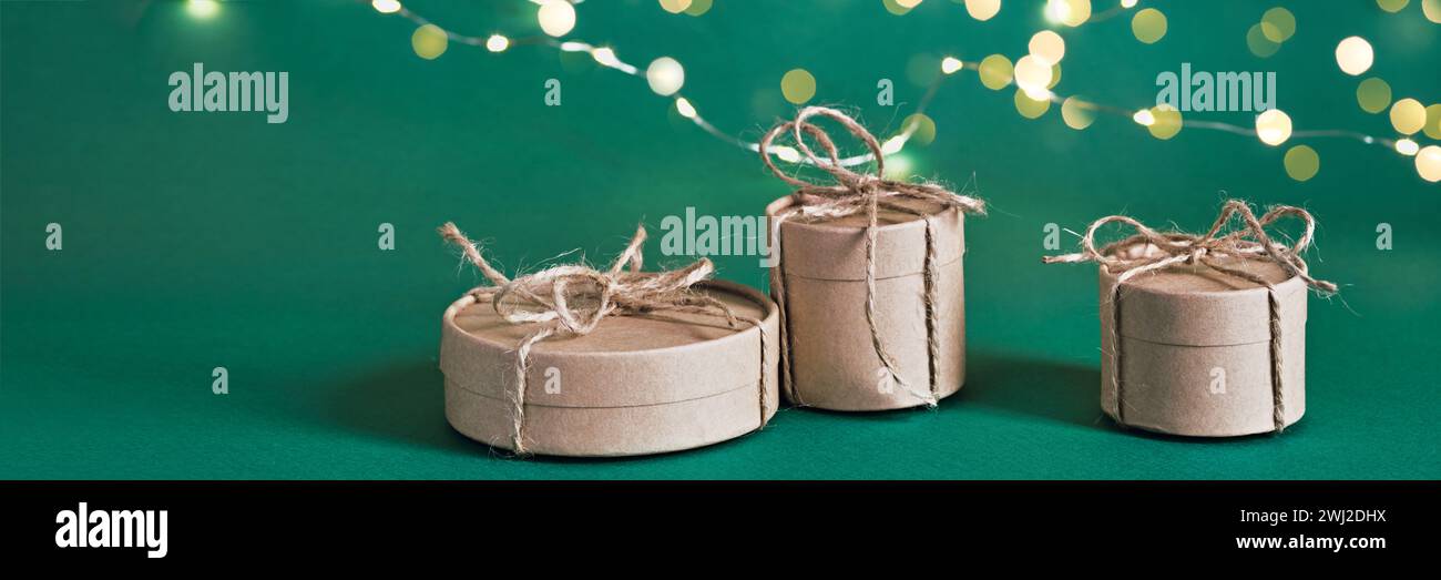 Christmas sustainable round gift boxes and shining garland on green ...