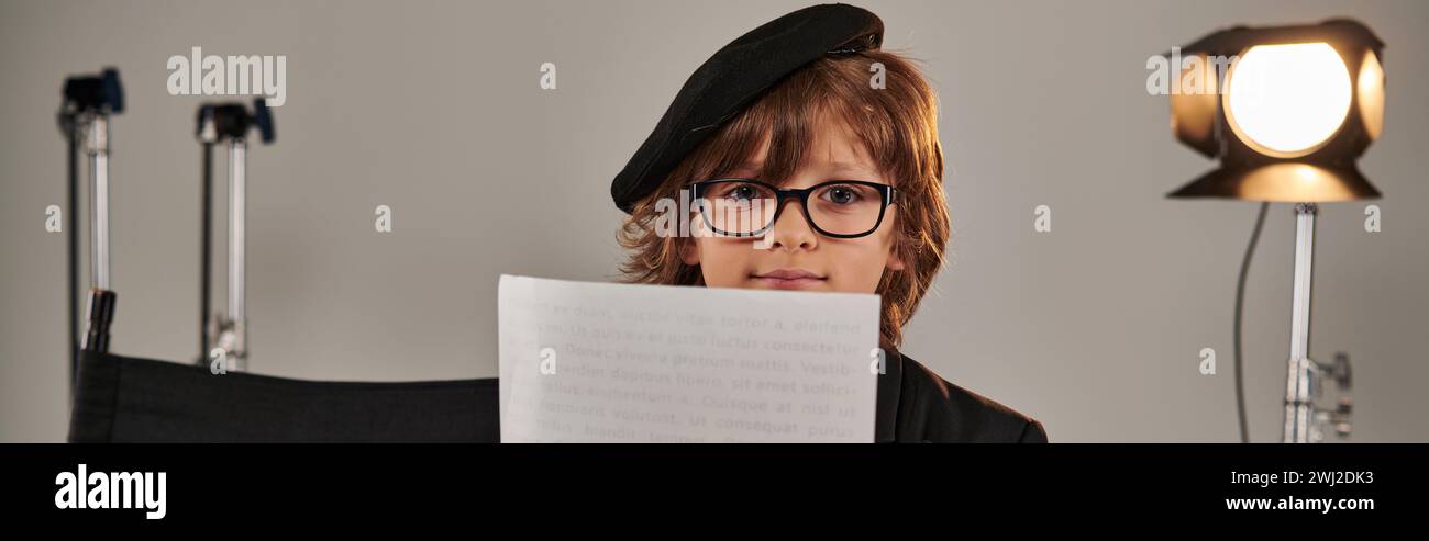 well-dressed kid in glasses and beret reading screenplay, boy as ...