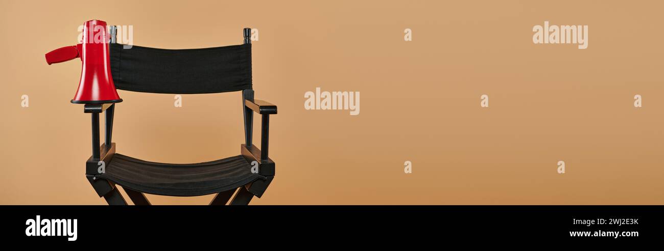 director chair with a red megaphone on beige background, cinematography ...
