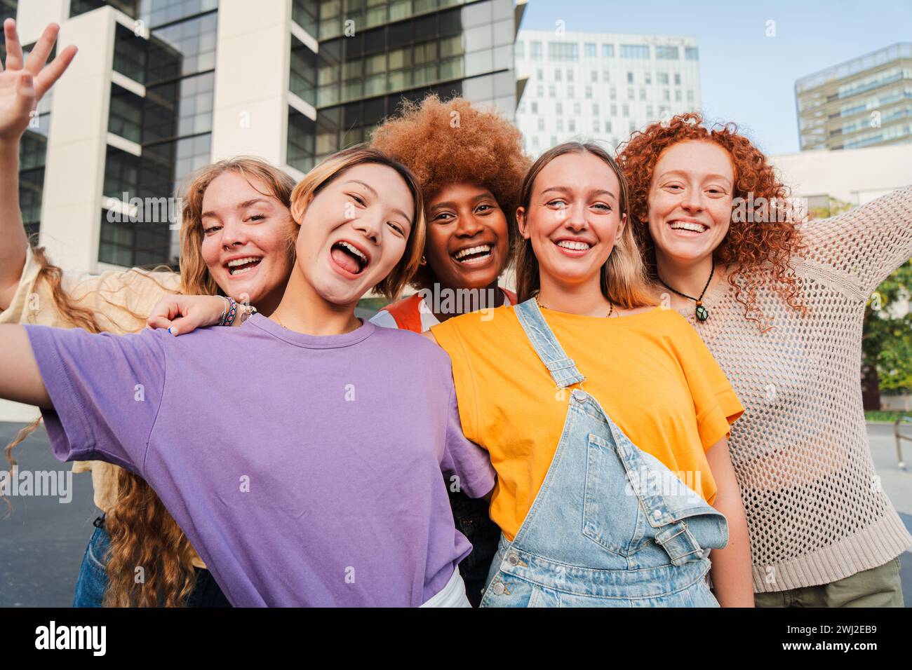 Social group of real young women are smiling and posing in front of a ...