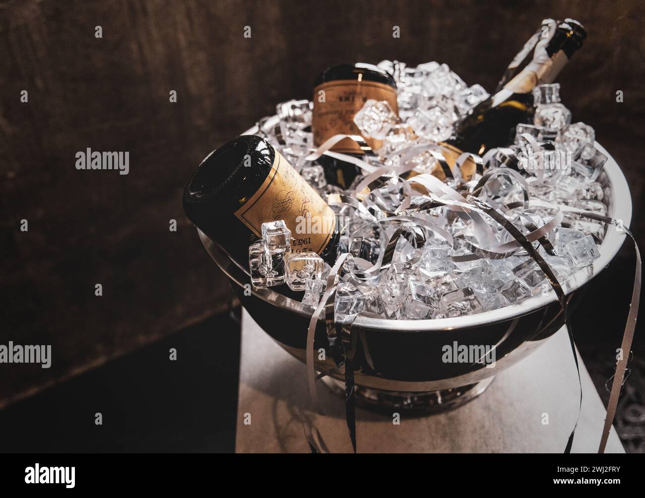 Empty vintage champagne bottles in a ice filled champagne bucket Stock ...