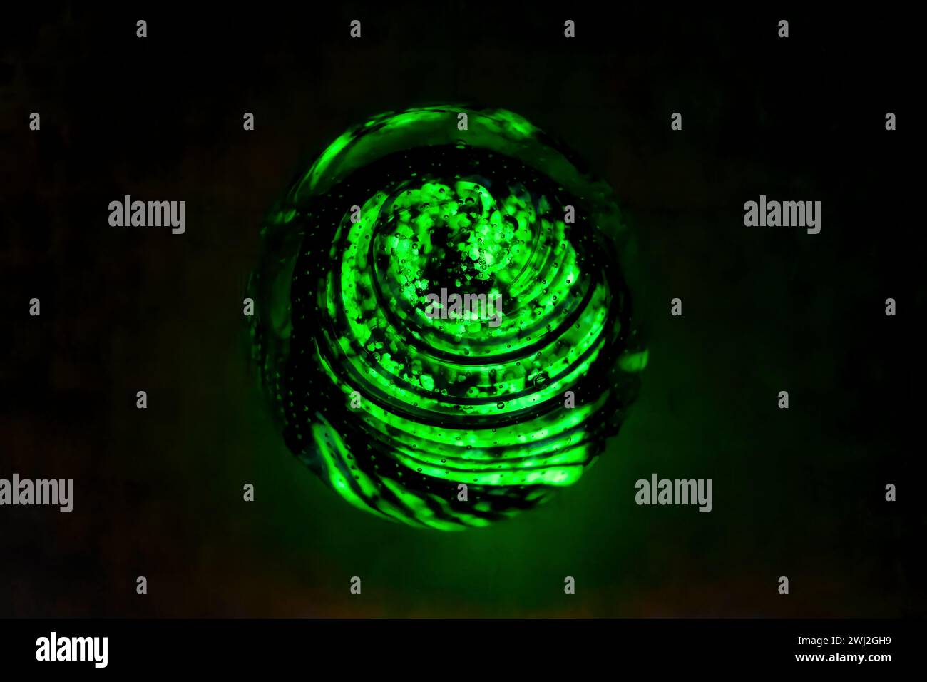 A transparent glass ball with inclusions casts real shadows on a white ...