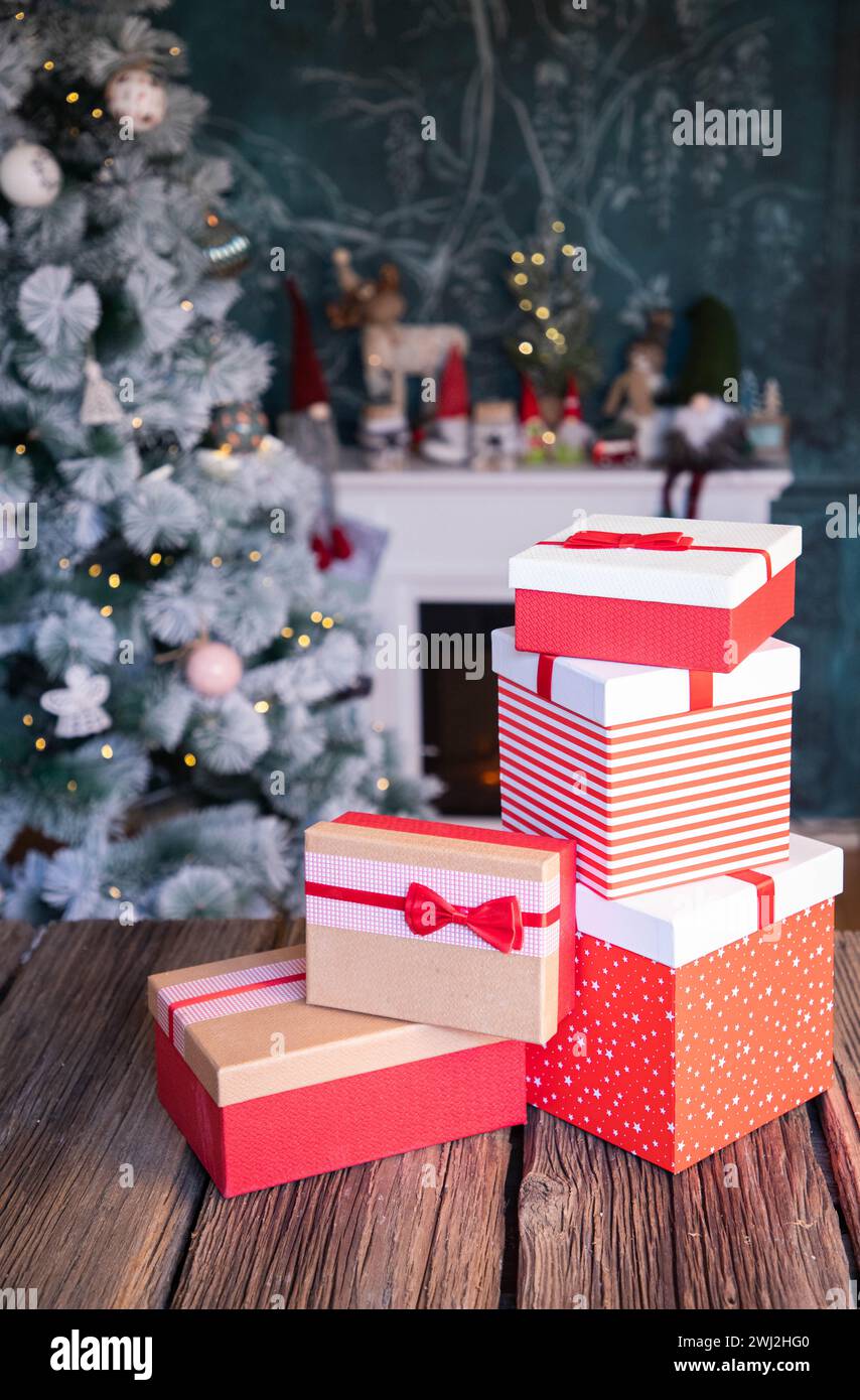 Gift boxes in front of Christmas tree Stock Photo - Alamy