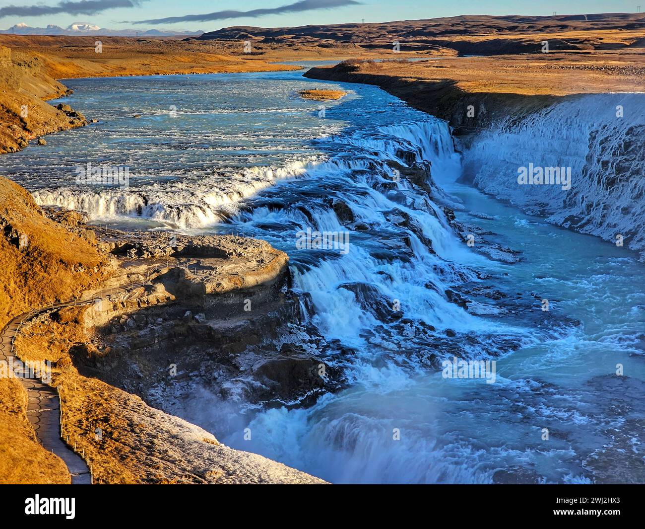 A stunning waterfall cascades into a vast body of water, Iceland Stock ...