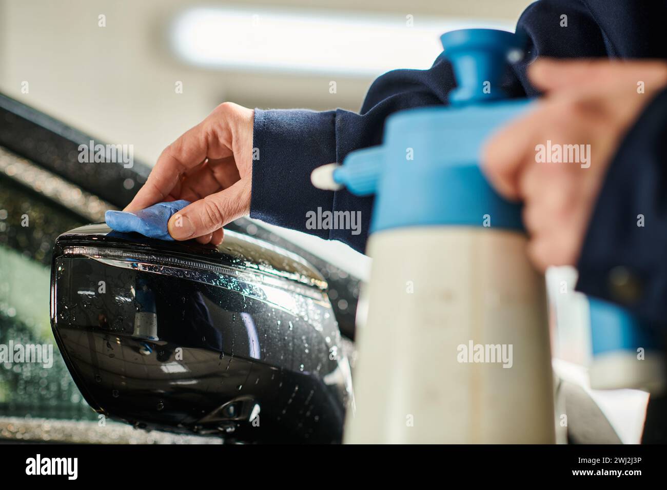 cropped view of hard working serviceman in uniform using pulverizer to ...