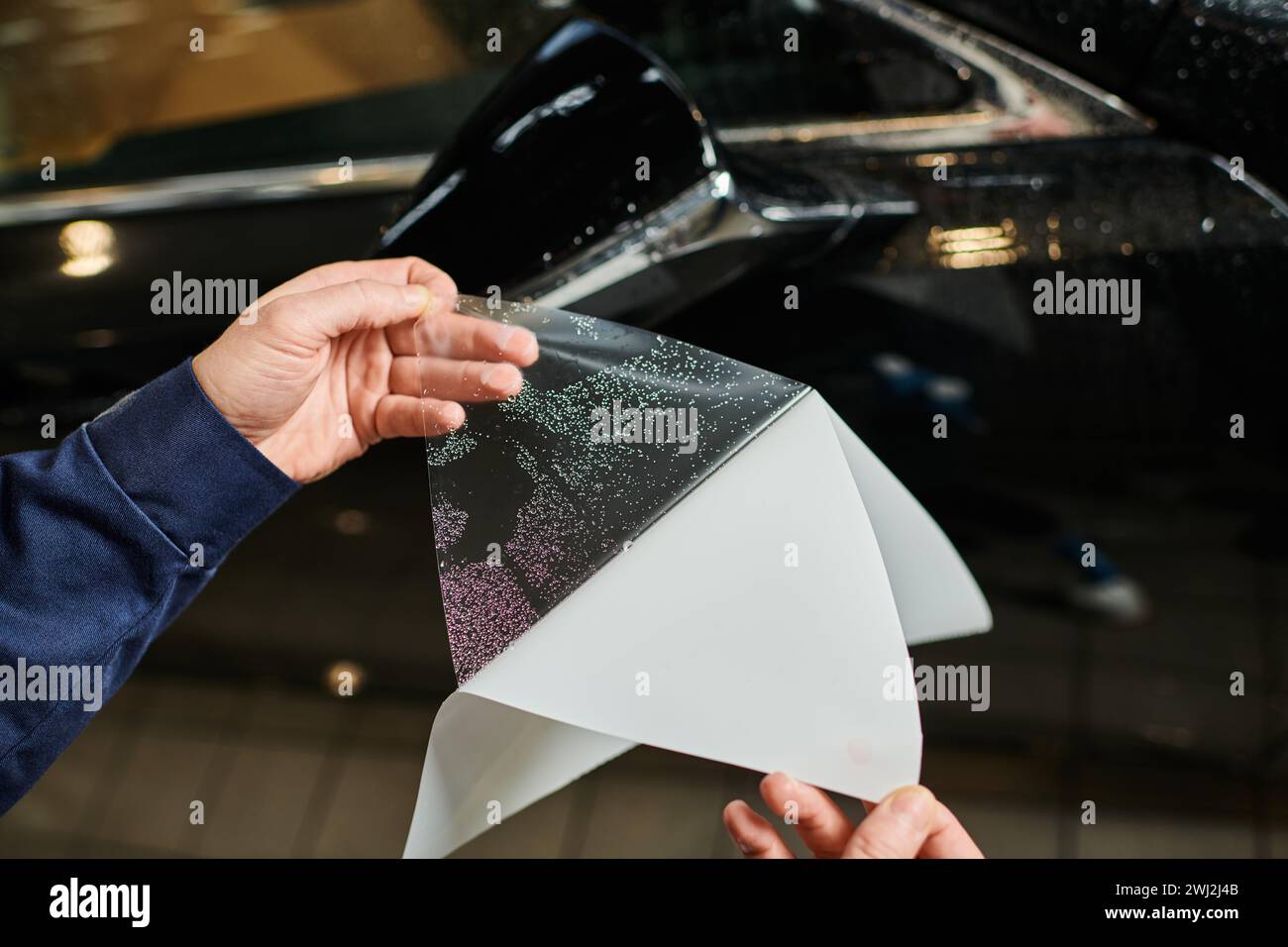 cropped view of devoted specialist in comfy blue uniform applying ...
