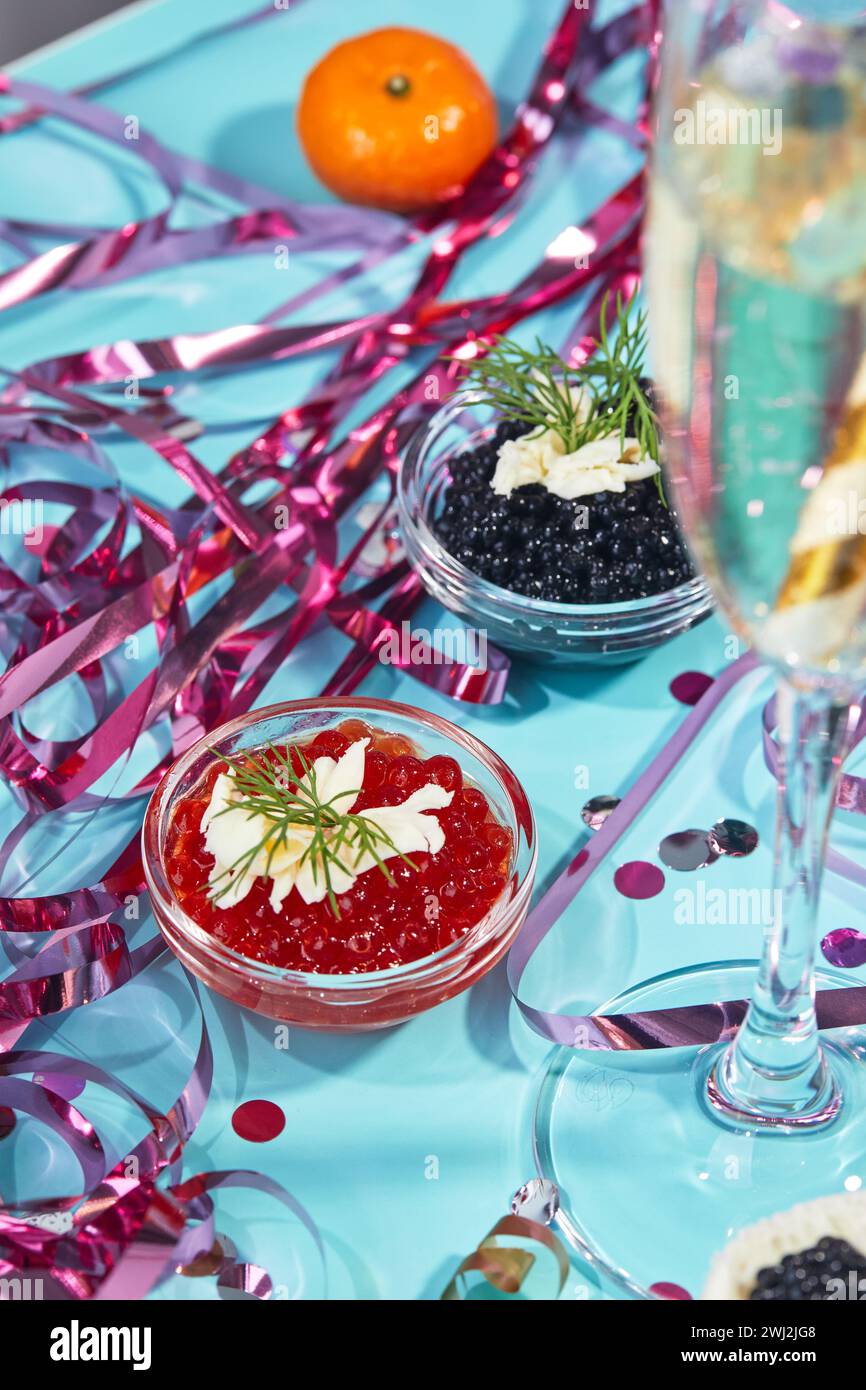 Two bowls with red and black caviar on the New Year's table. Party in ...
