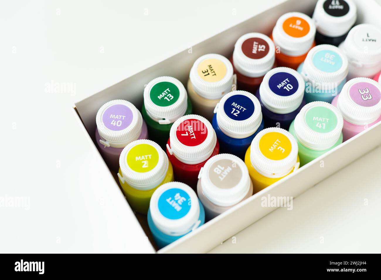 A box of colorful paint bottles, neatly arranged, showcasing vibrant ...
